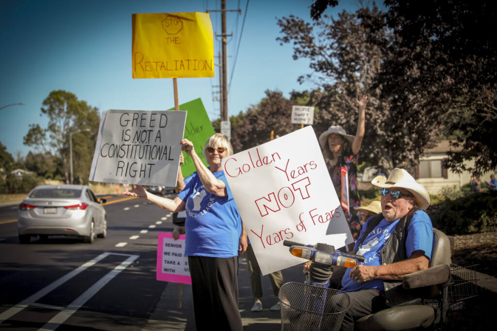 Christina Yonkers (left) and Donald “Olie” Olson protest outside of ...